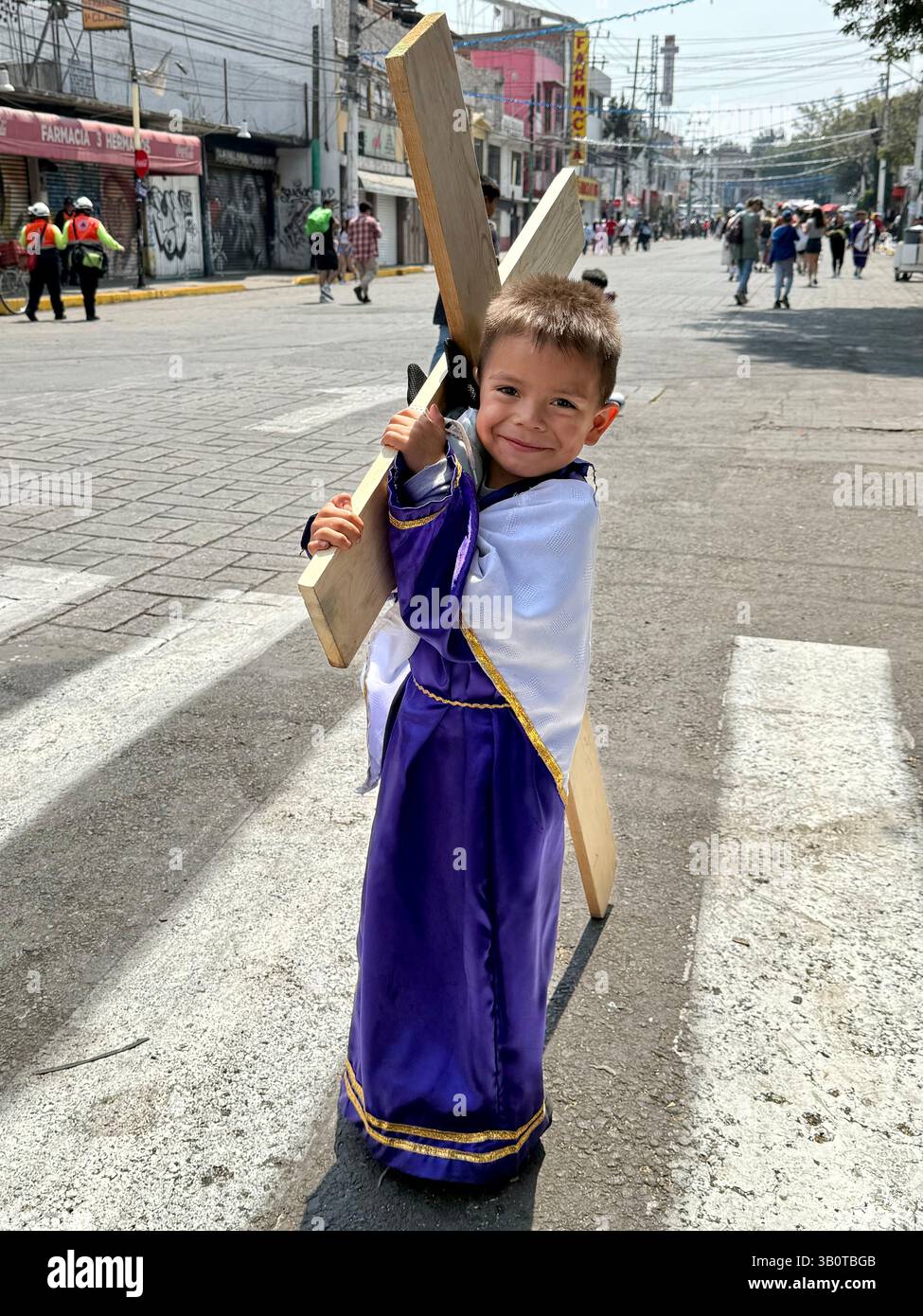 On Holy Friday in Iztapalapa, faithful child carry large wooden cross ...