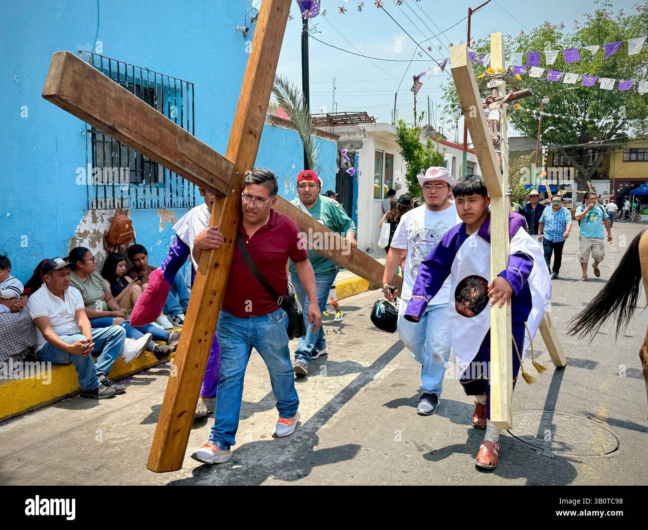 On Holy Friday in Iztapalapa, faithful people carry large wooden ...
