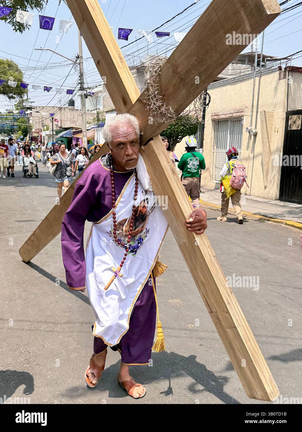 On Holy Friday in Iztapalapa, faithful people carry large wooden ...