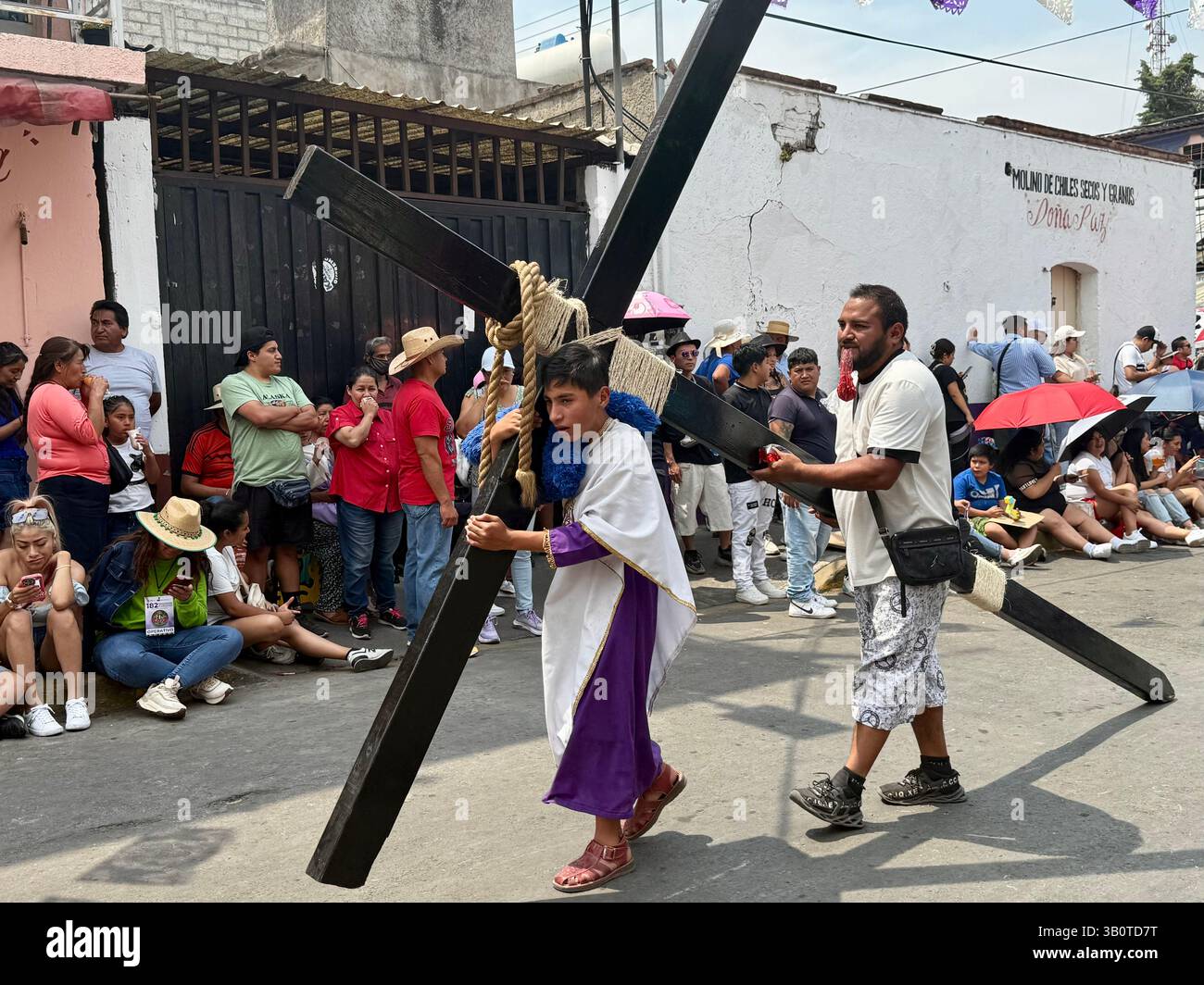 On Holy Friday in Iztapalapa, faithful people carry large wooden ...