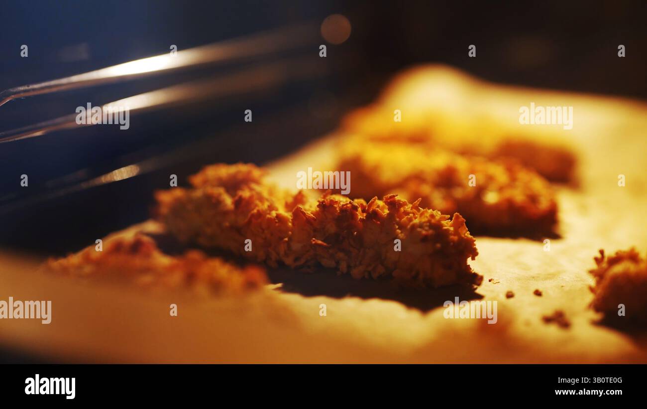 Baking chicken strips in oven hi-res stock photography and images - Alamy