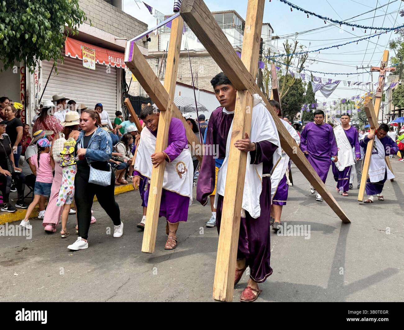 On Holy Friday in Iztapalapa, faithful people carry large wooden ...