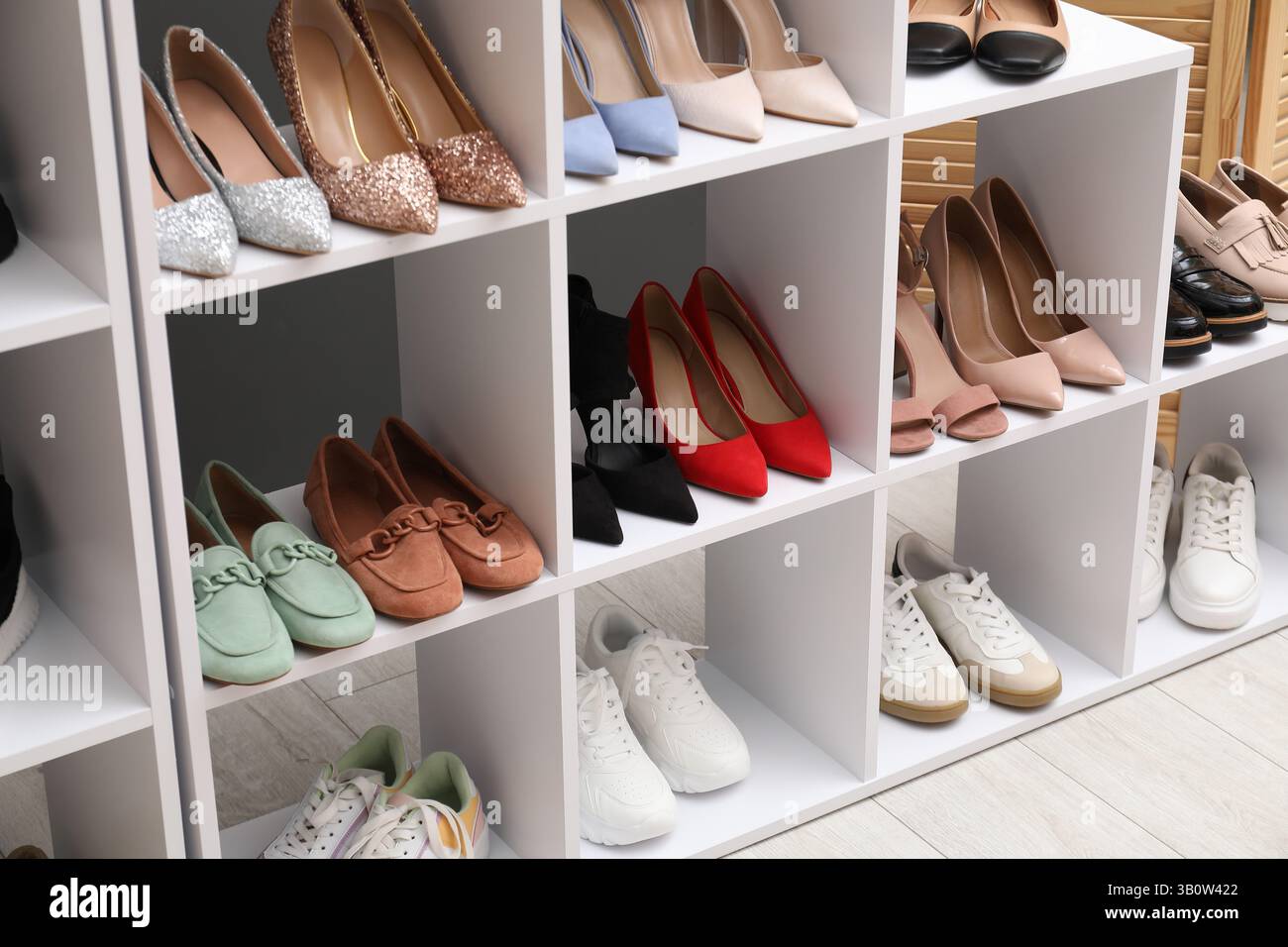 Shoe storage. Shelving unit with different footwear indoors Stock Photo ...