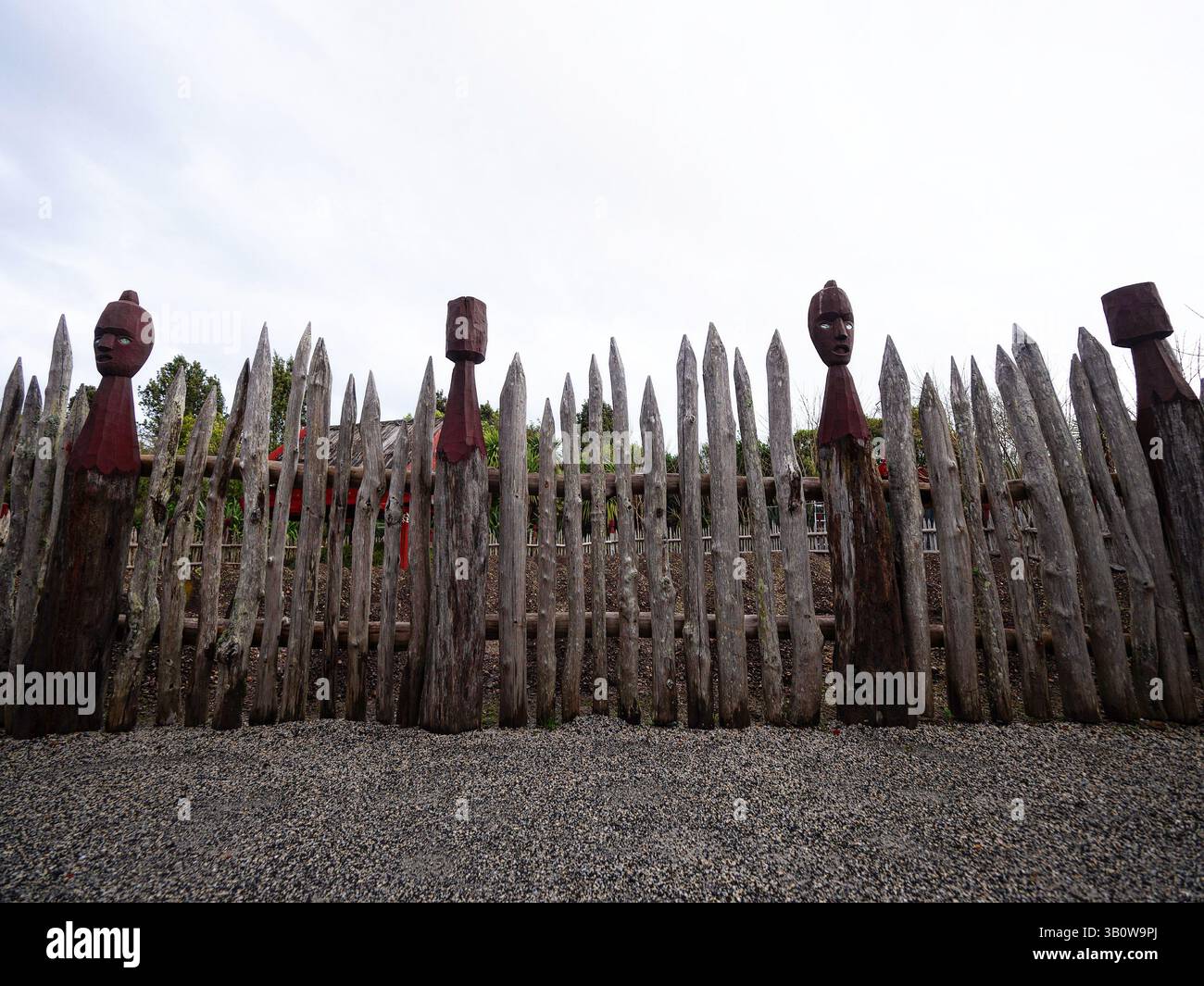 Wooden fence with Maori carvings at Te Parapara traditional indigenous ...