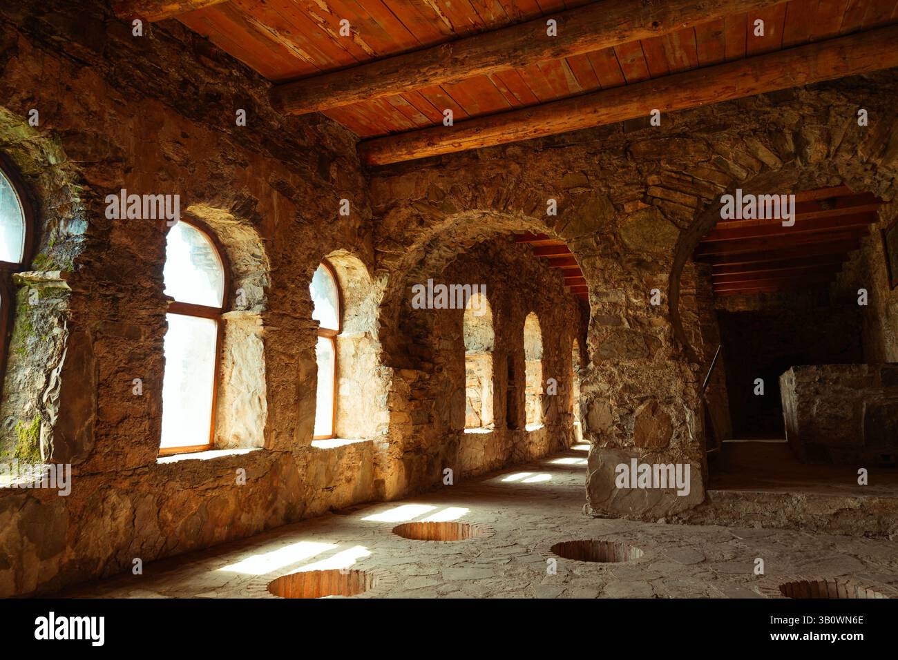 Traditional Georgian wine cellar with sunlit arched windows and ...