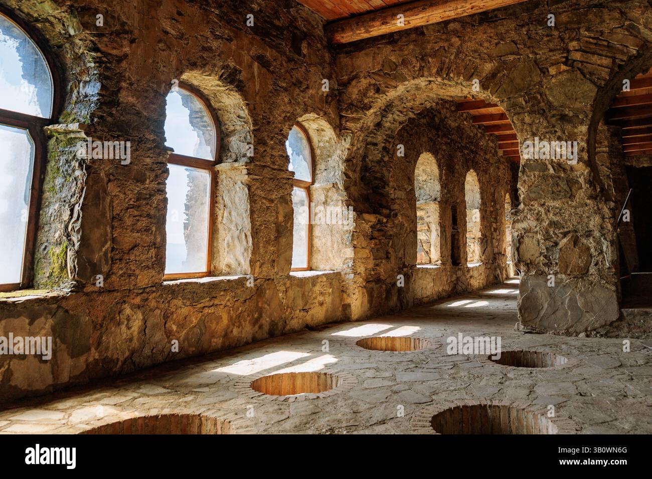 Traditional Georgian wine cellar with sunlit arched windows and ...