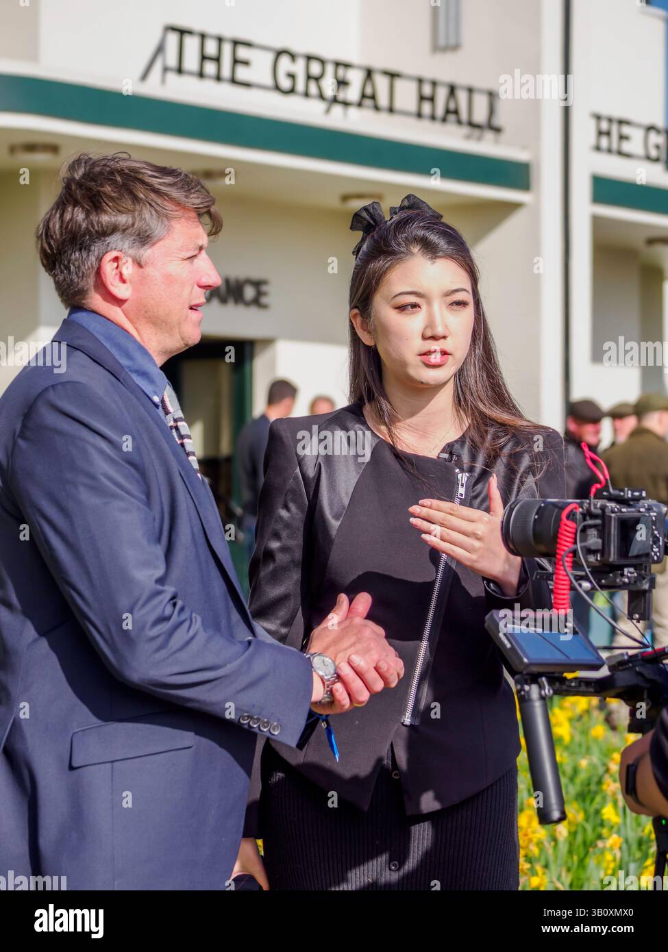 A male and female TV presenters at the 82 Members Meeting, Goodwood ...