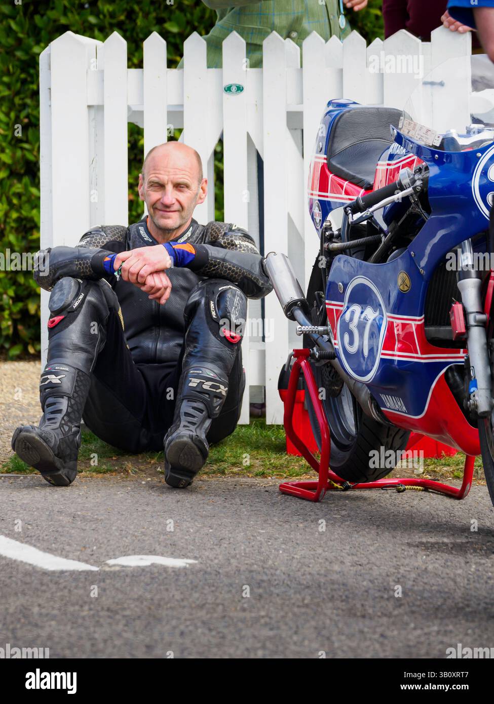 A motor bike rider sitting beside his racing bike at the 82 Members ...