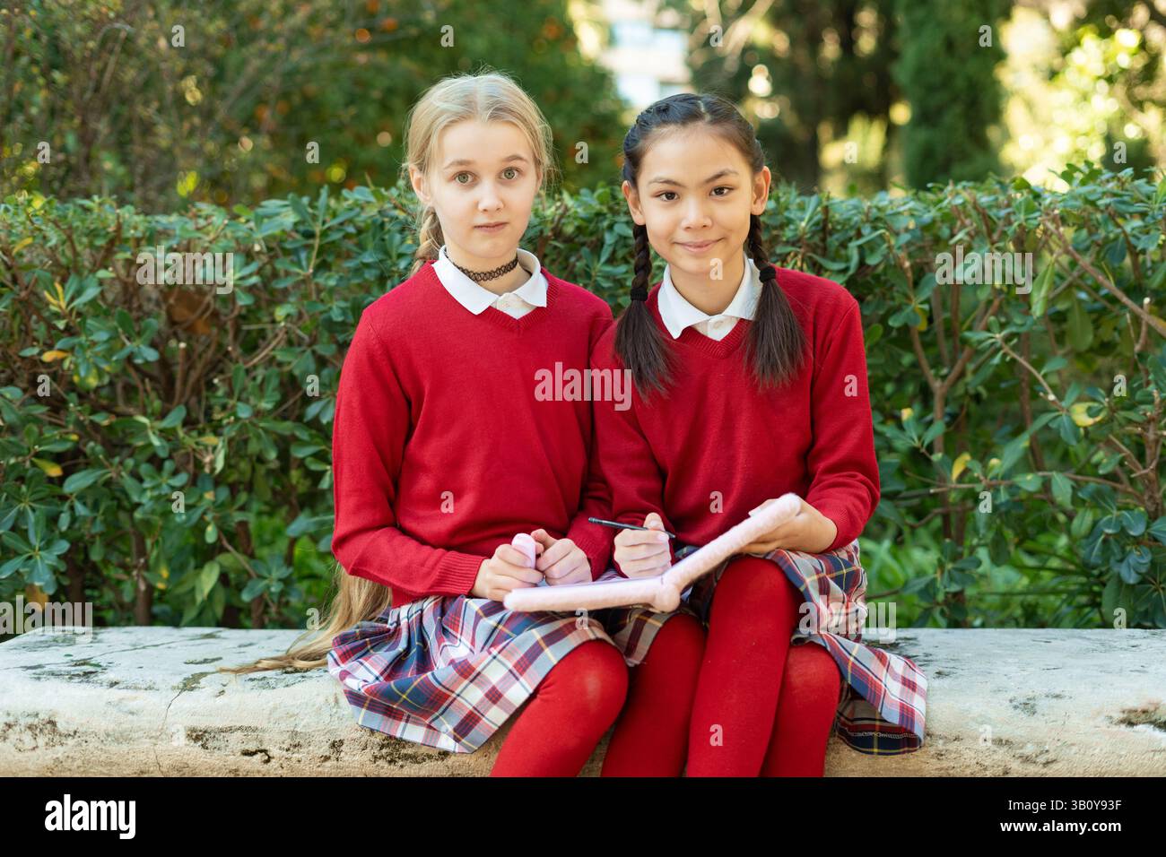 Two cheerful schoolgirls wearing hi-res stock photography and images ...