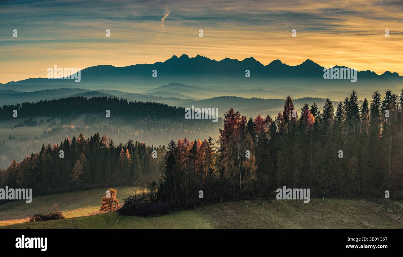 The silhouette of the Tatra Mountains in the light of sunset, with ...