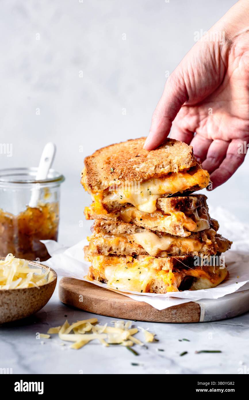 Hand reaches gooey cheese hi-res stock photography and images - Alamy
