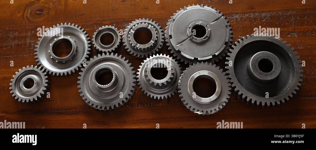 Metal cog wheels bonding together Stock Photo - Alamy