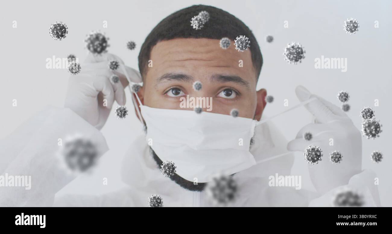 Man wearing white coverall and latex gloves, adjusting surgical mask in ...