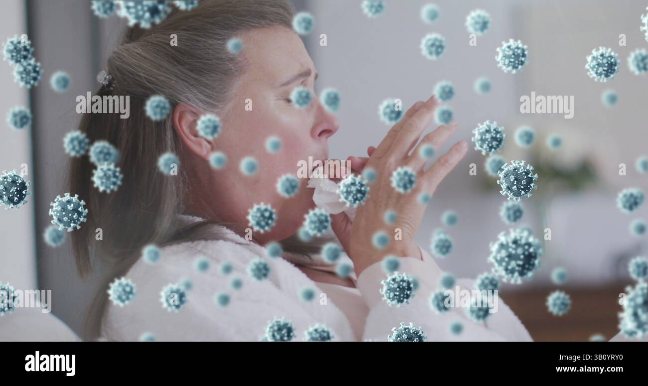 Sneezing mature woman holding crumpled tissue in softly lit home, with ...