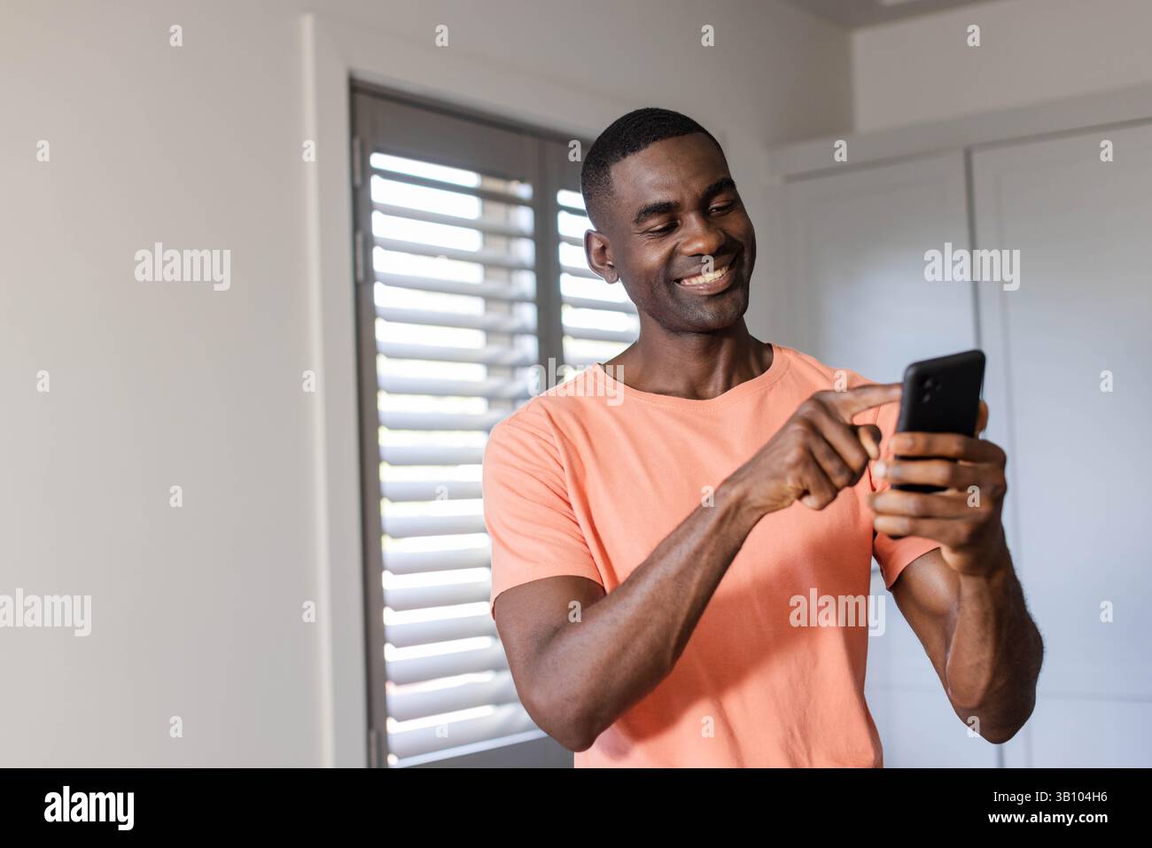 Smiling african american man tapping hi-res stock photography and ...