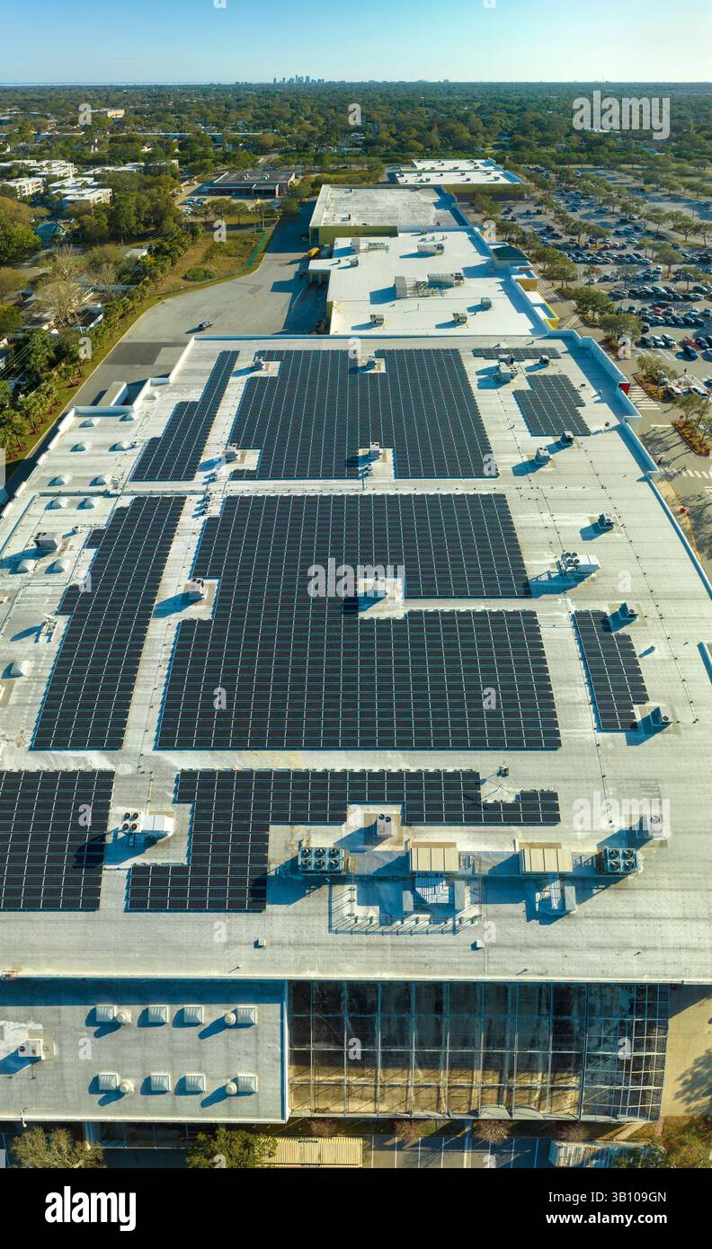 Aerial view of blue photovoltaic solar panels mounted on shopping mall ...