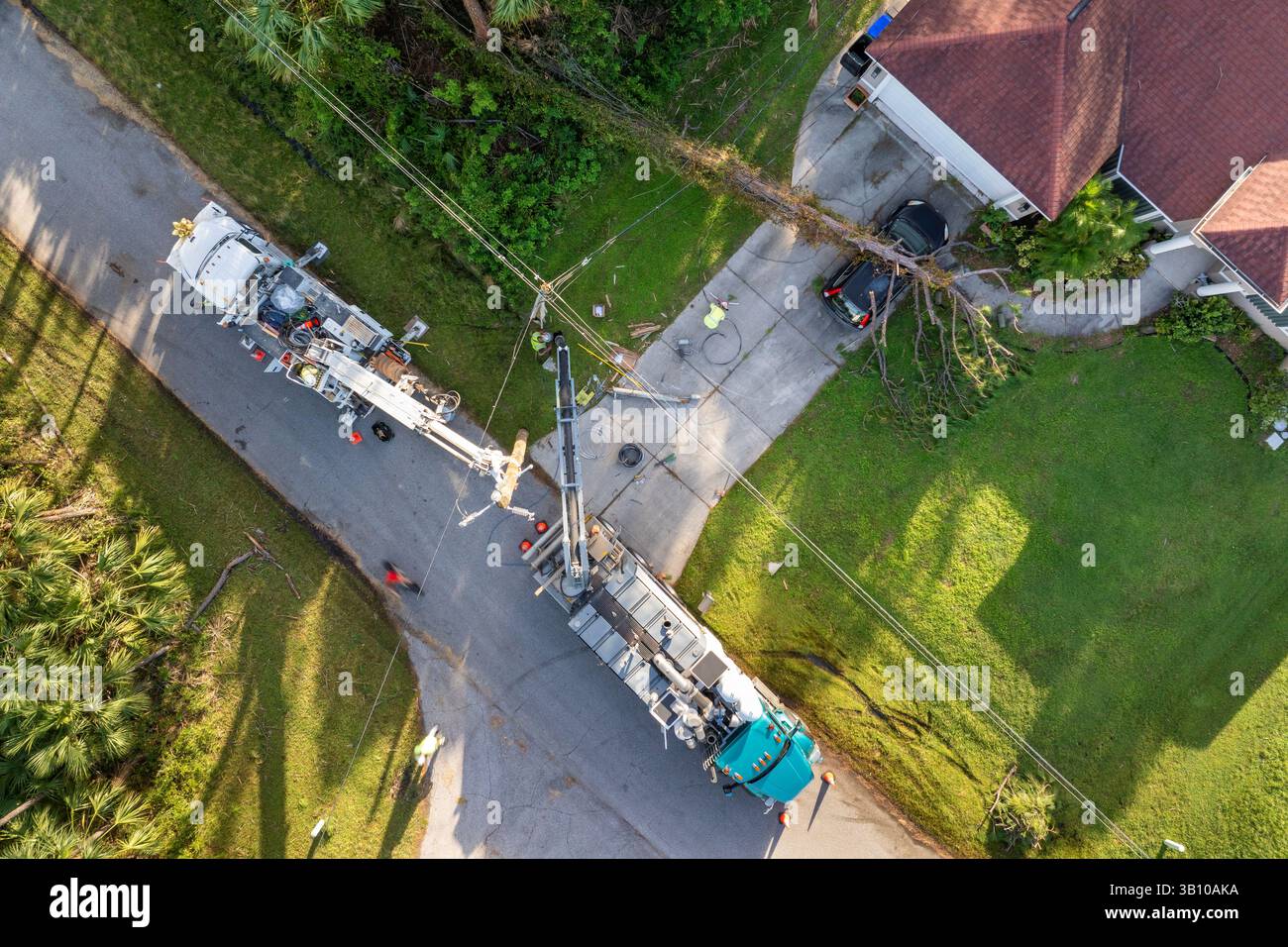 Aerial view of electrician workers repairing damaged power lines after ...