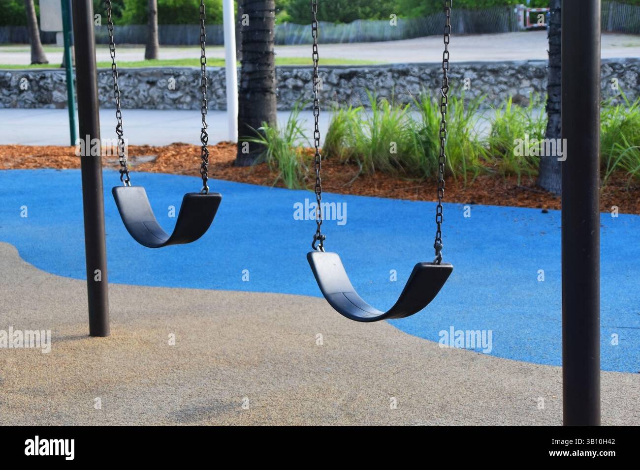 Empty swings in an American children's park, evoking a quiet, nostalgic ...