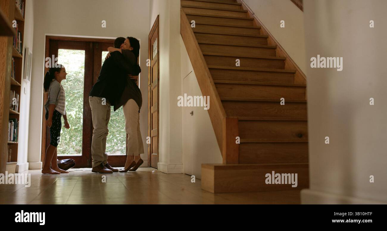 Hug, man and greeting family in home for welcome, affection and return ...