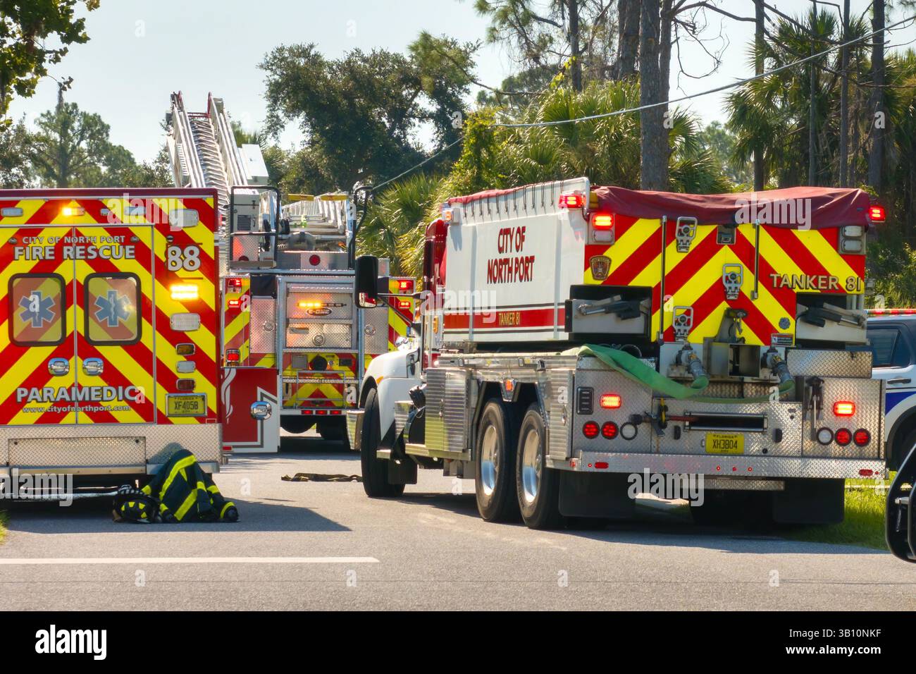 Firefighter trucks at fire alarm scene of suburban house. First ...