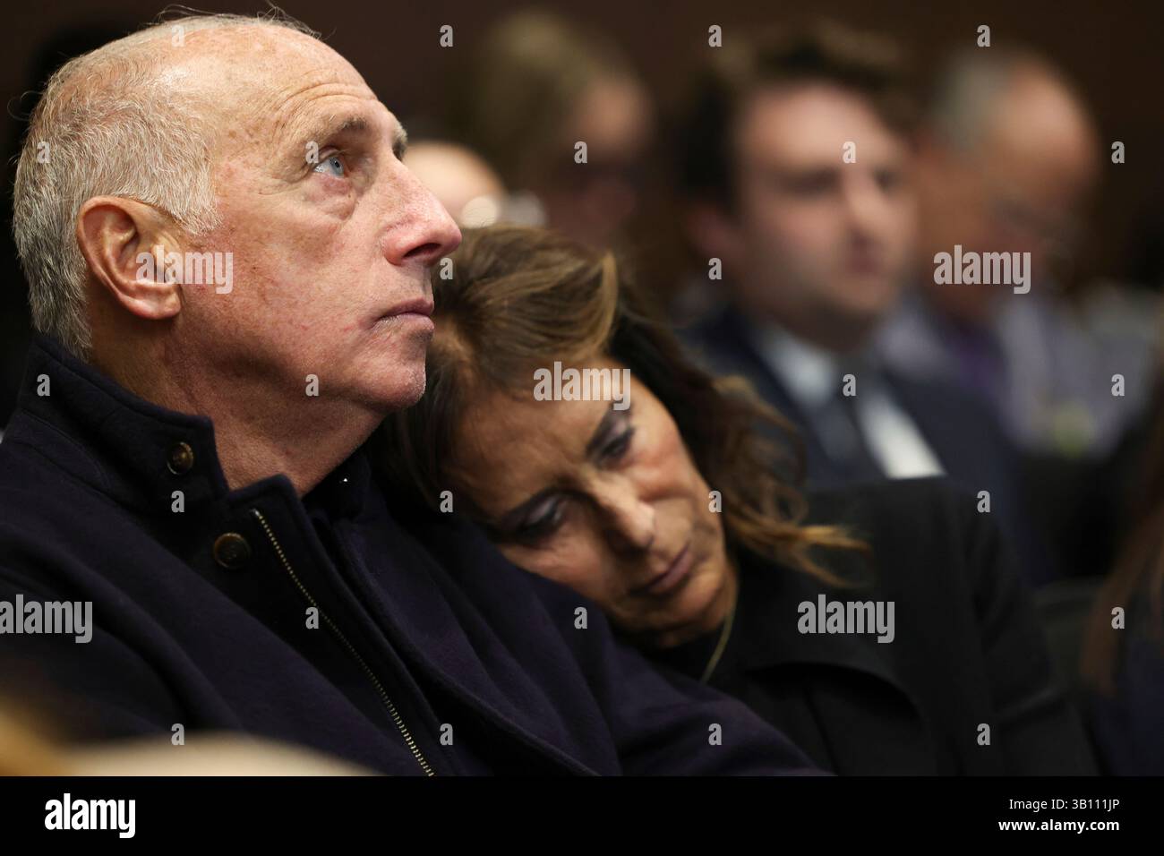 Joe Gutman looks up as his wife, Sheila Gutman, right, puts her head on ...
