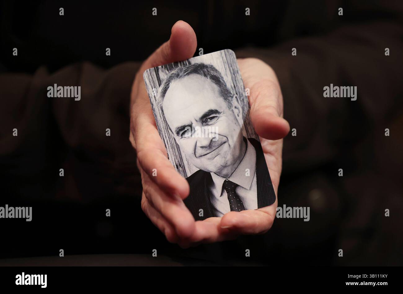 Erica Weeder holds a photo of her husband, John Kezdy, in her hands ...