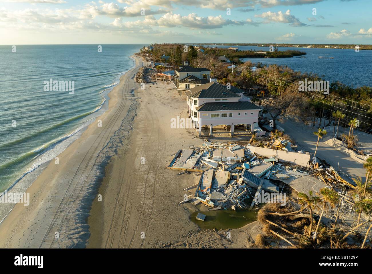 Ruined buildings in need of demolition or repair. Storm surge water and ...