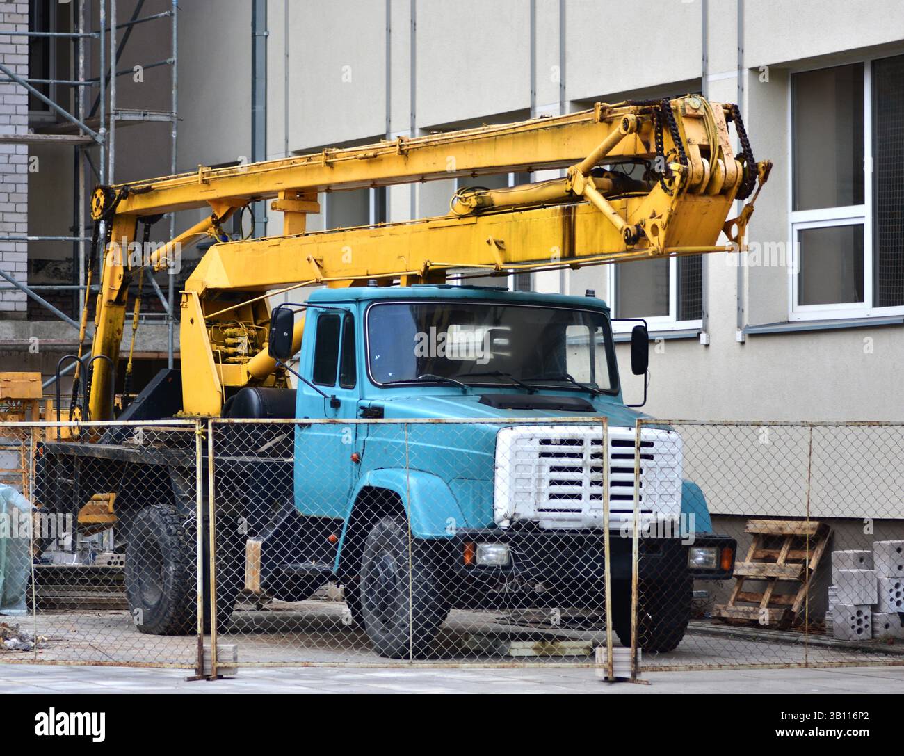 Old school russian vintage man lifter crane truck service standing near ...