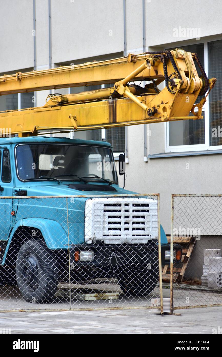 Old school russian vintage man lifter crane truck service standing near ...