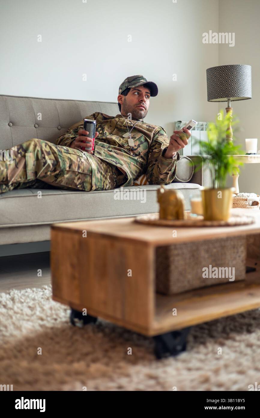 Depressed veteran in camouflage uniform suffering from post-traumatic ...