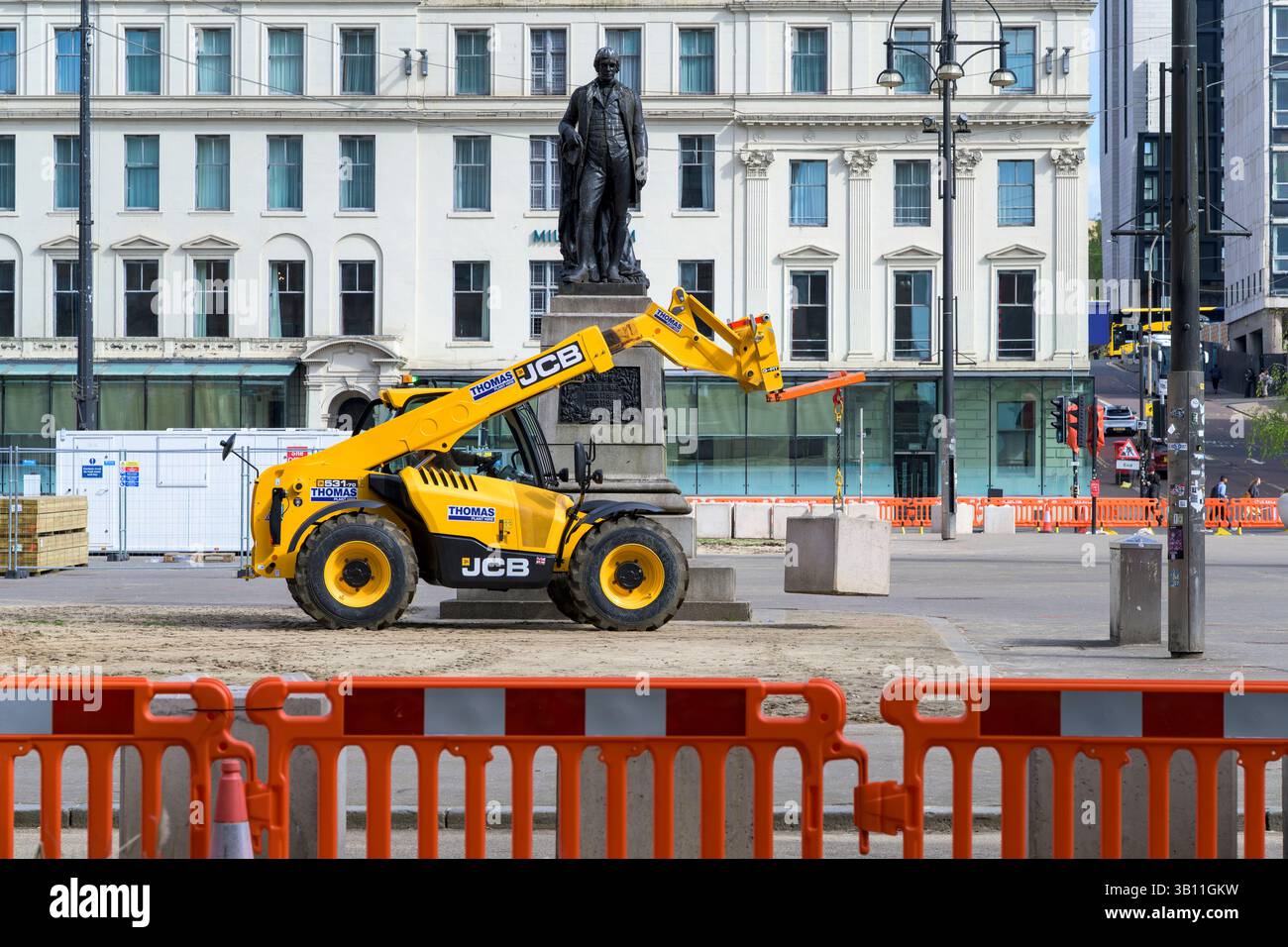 A JCB Telehandler being used to move concrete barrier blocks into place ...