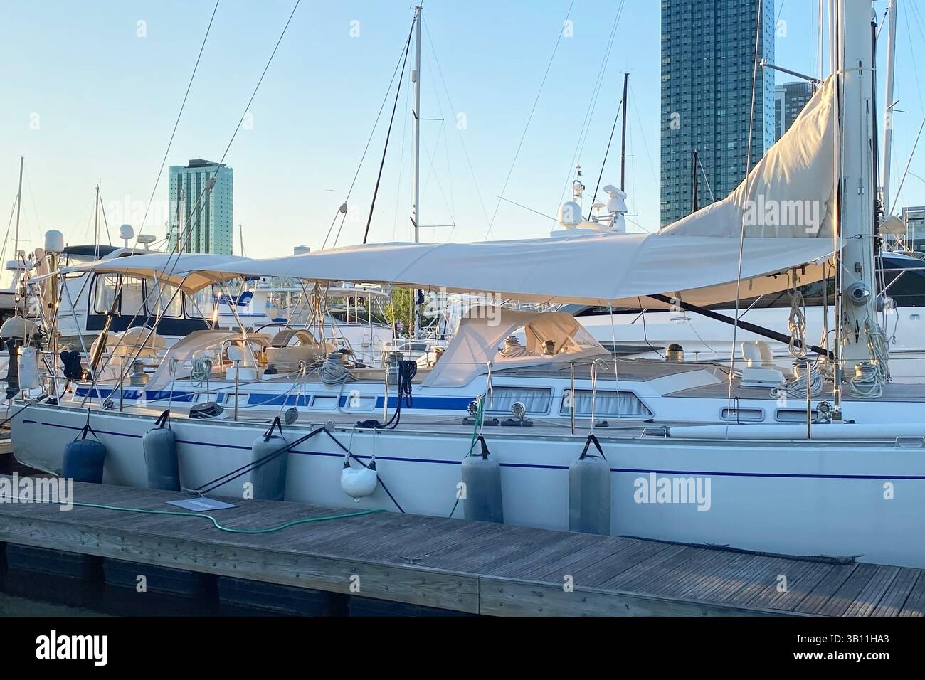Boat docked in the port of a New Jersey city, calm waterfront scene ...