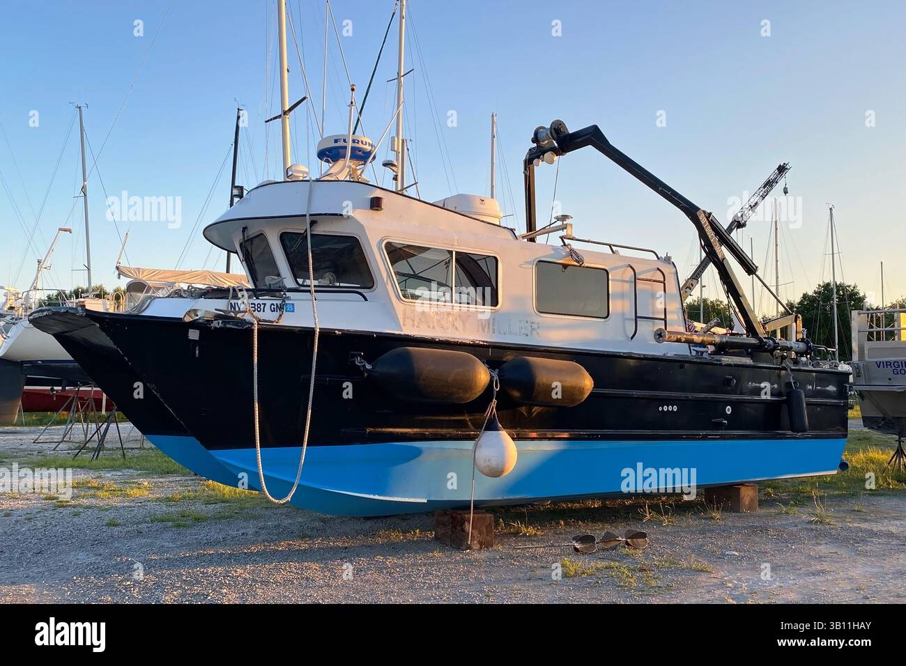 Boat docked in the port of a New Jersey city, calm waterfront scene ...
