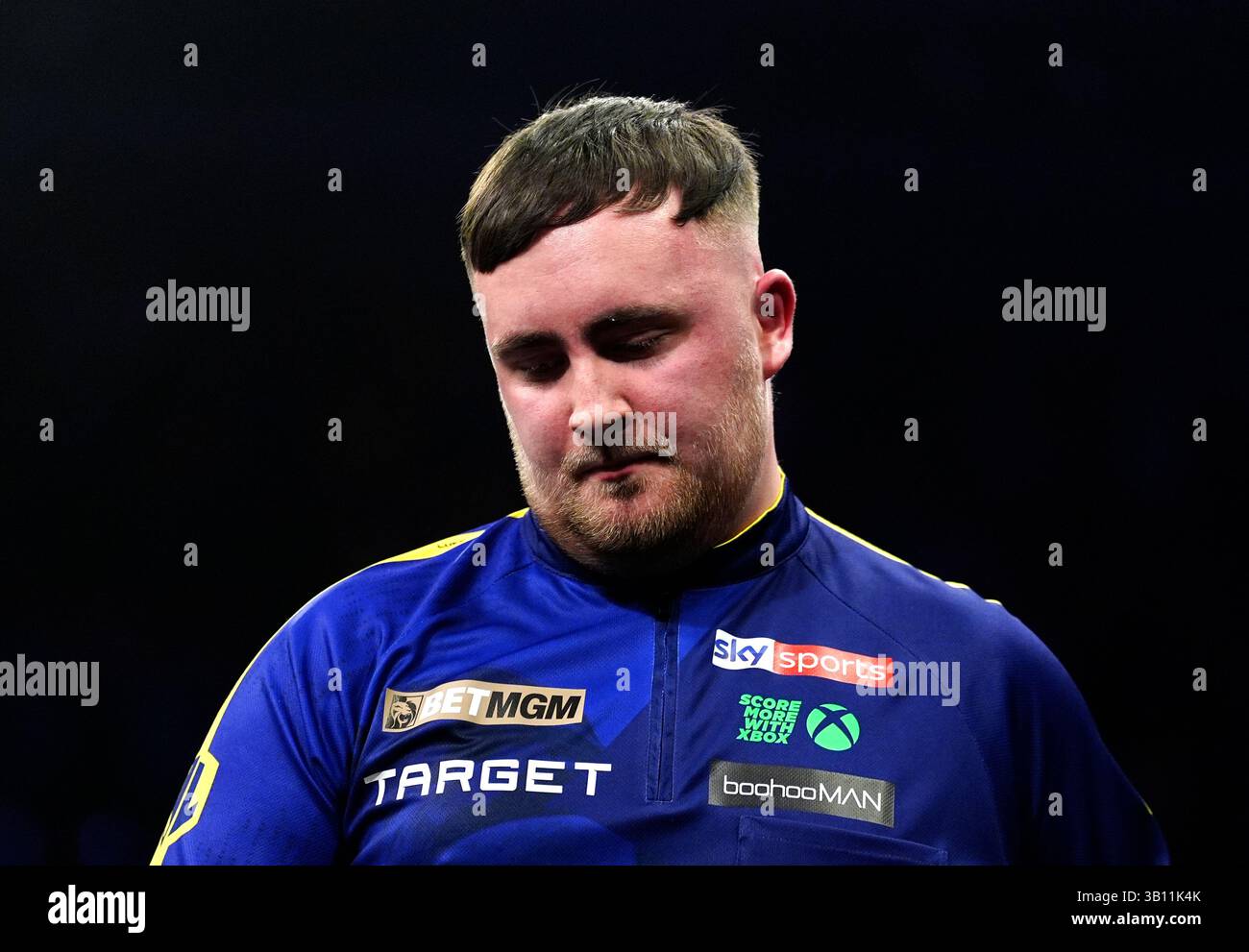 Luke Littler reacts to defeat to Michael van Gerwen (not pictured ...