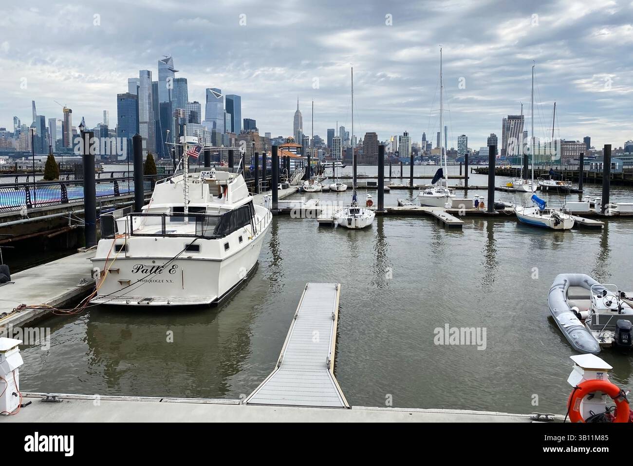 Boat docked in the port of a New Jersey city, calm waterfront scene ...