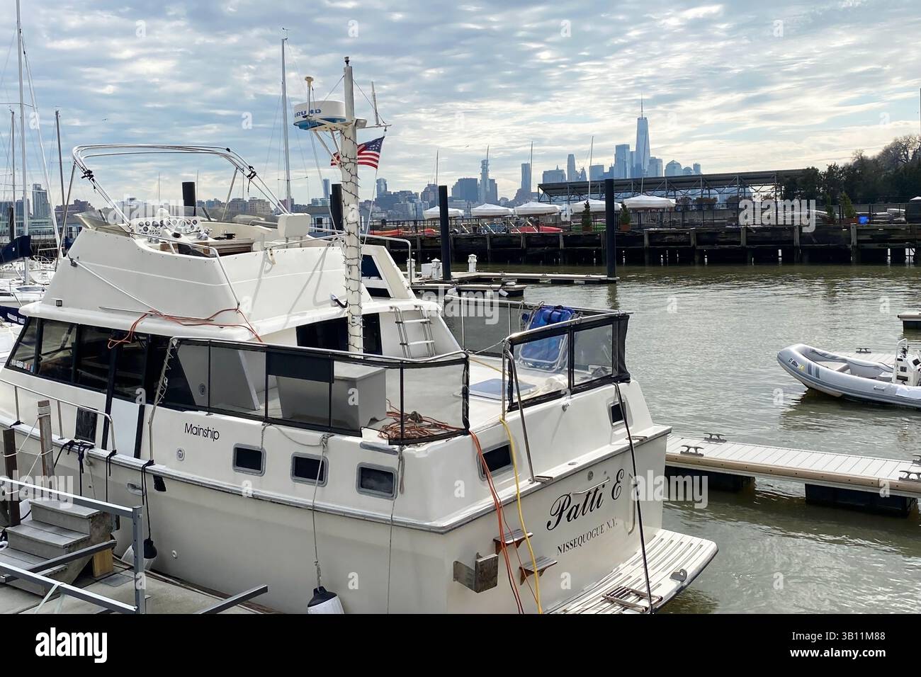 Boat docked in the port of a New Jersey city, calm waterfront scene ...