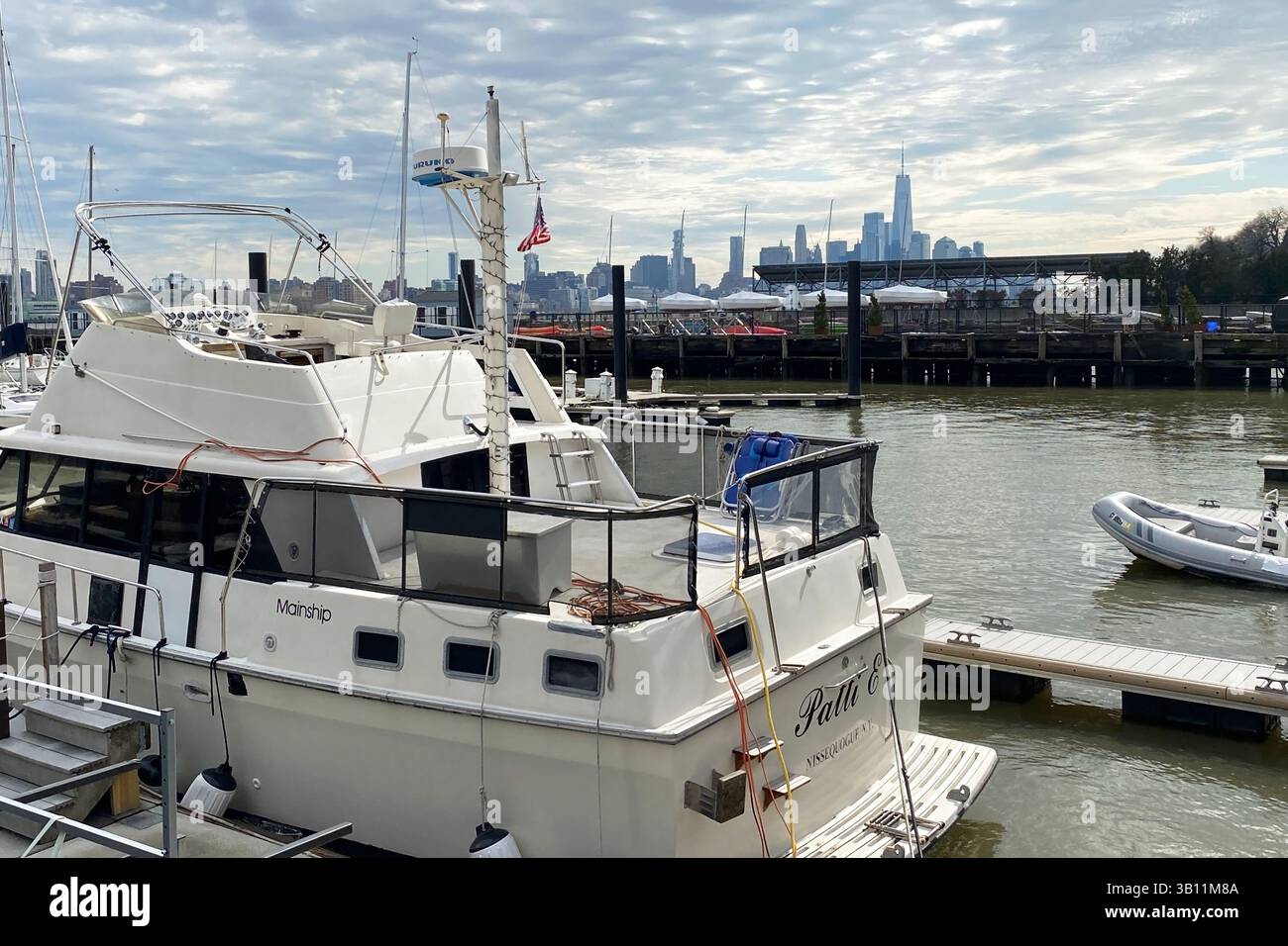 Boat docked in the port of a New Jersey city, calm waterfront scene ...