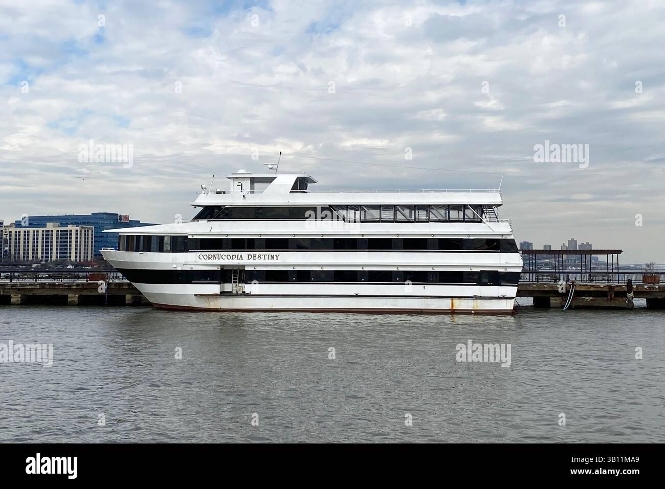Boat docked in the port of a New Jersey city, calm waterfront scene ...