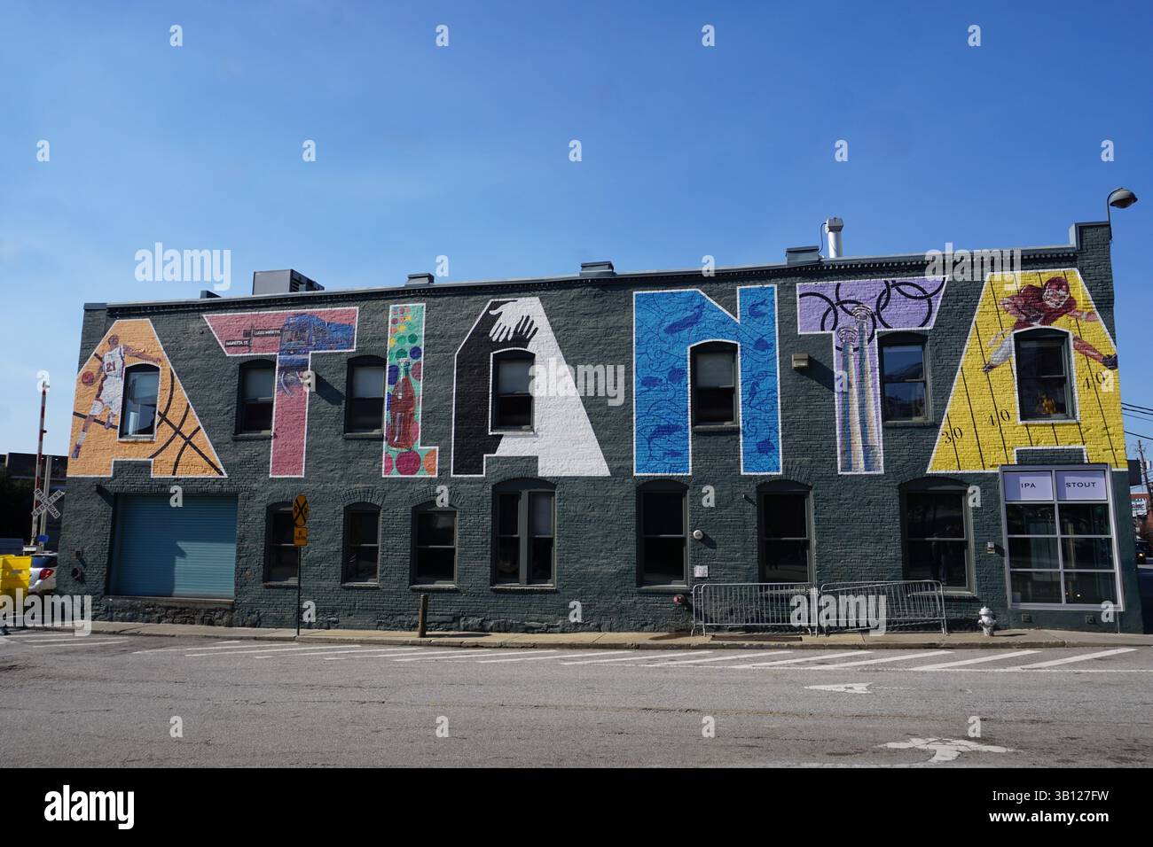 A colorful street art graffiti mural in downtown Atlanta, Georgia pays ...