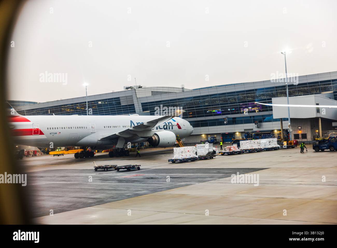 American Airlines aircraft parked near terminal with cargo being loaded ...