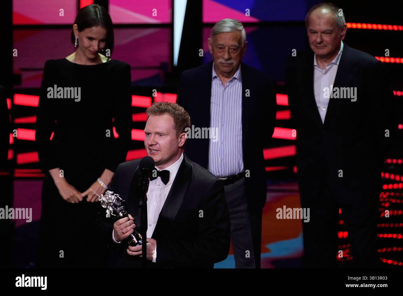 Russian director Anton Maslov, front, holds his Silver George award for best film in the Russian ...