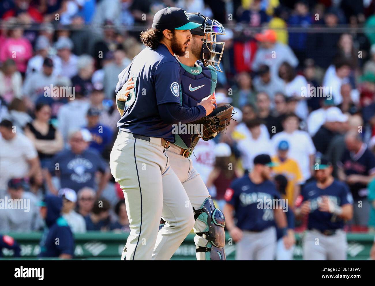 Seattle Mariners pitcher Andrés Muñoz, left, hugs catcher Mitch Garver ...