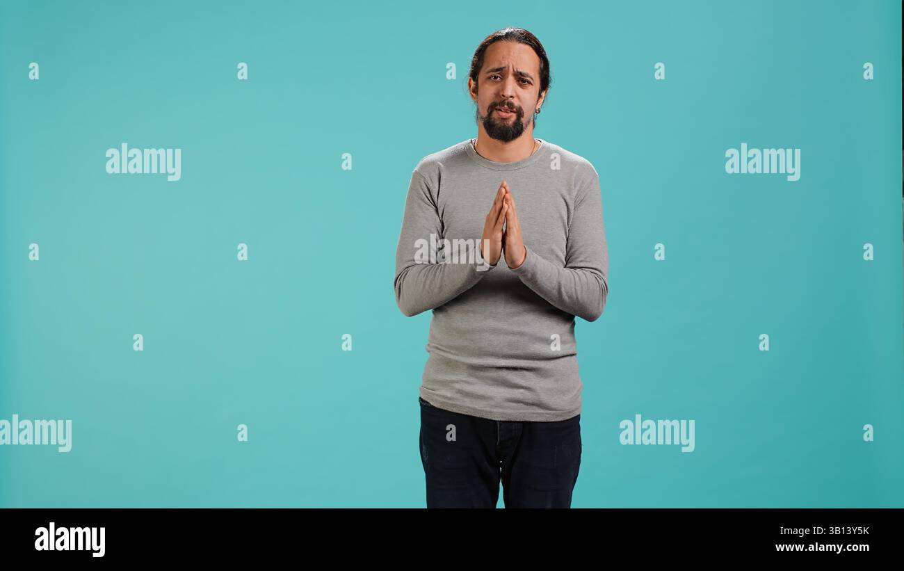 Man putting hands together in apology gesture, asking for forgiveness ...