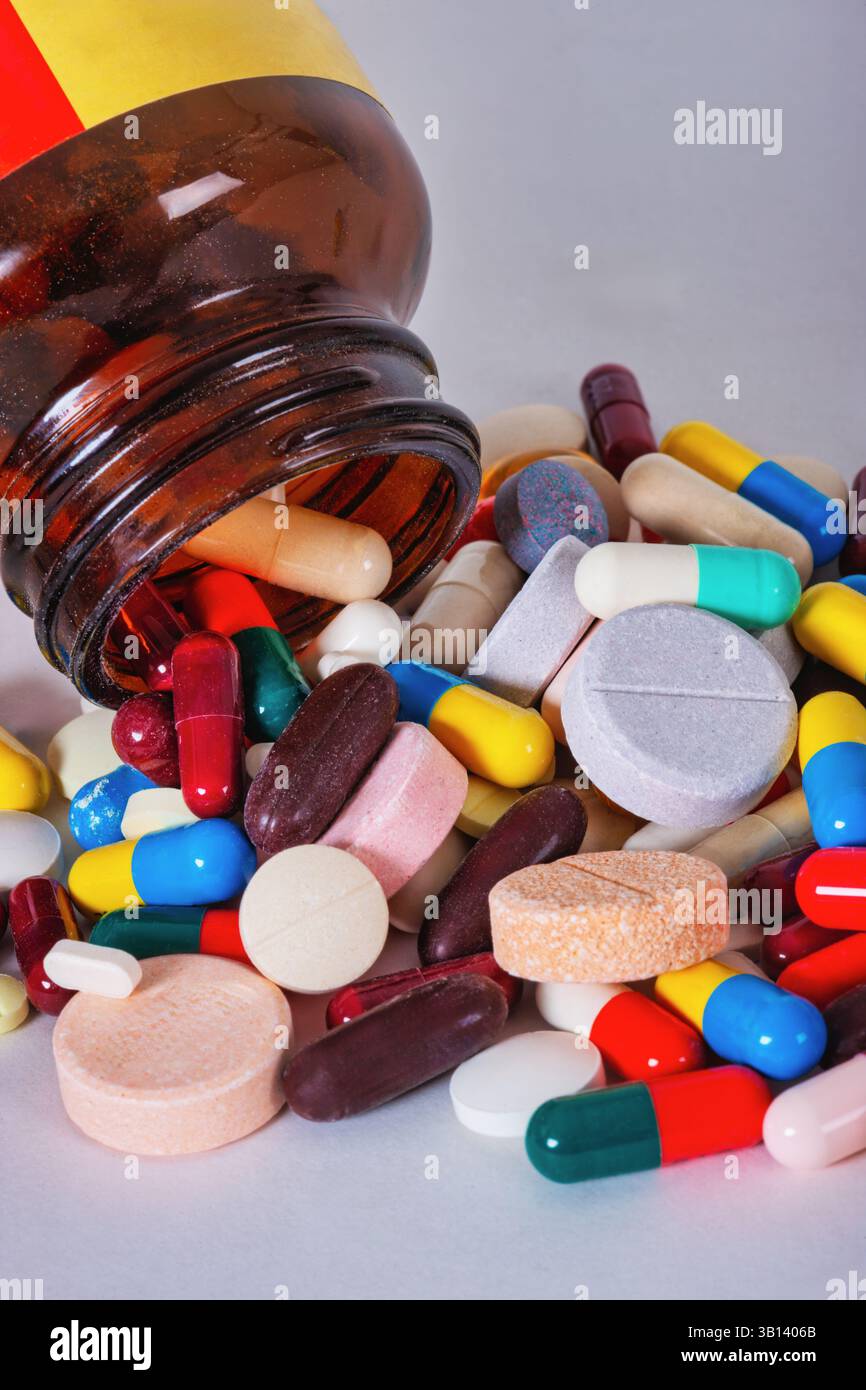 medication pills and capsules out of a bottle, addiction excess ...
