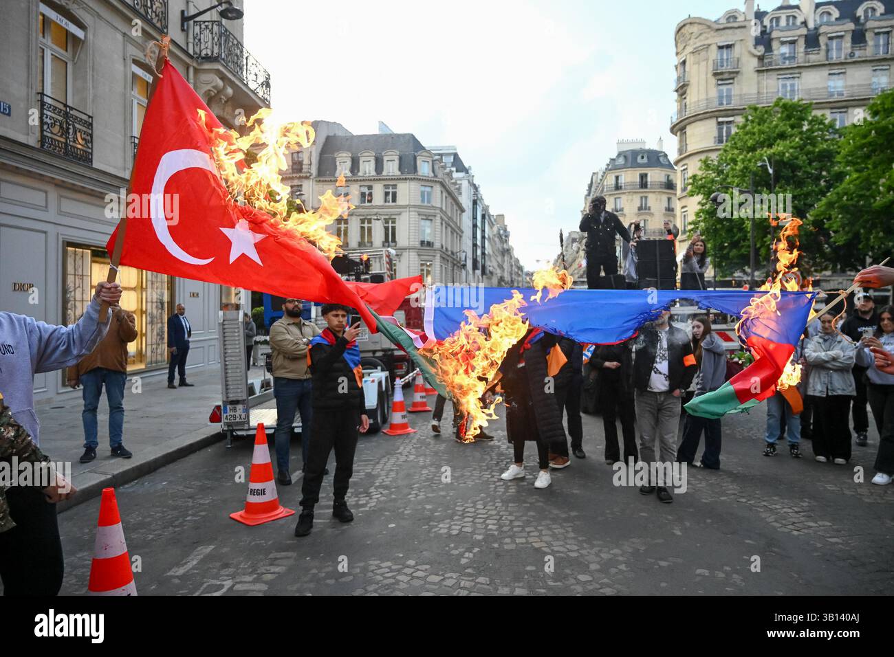 Protesters burn the flags of Turkey and Azerbaijan during the ...