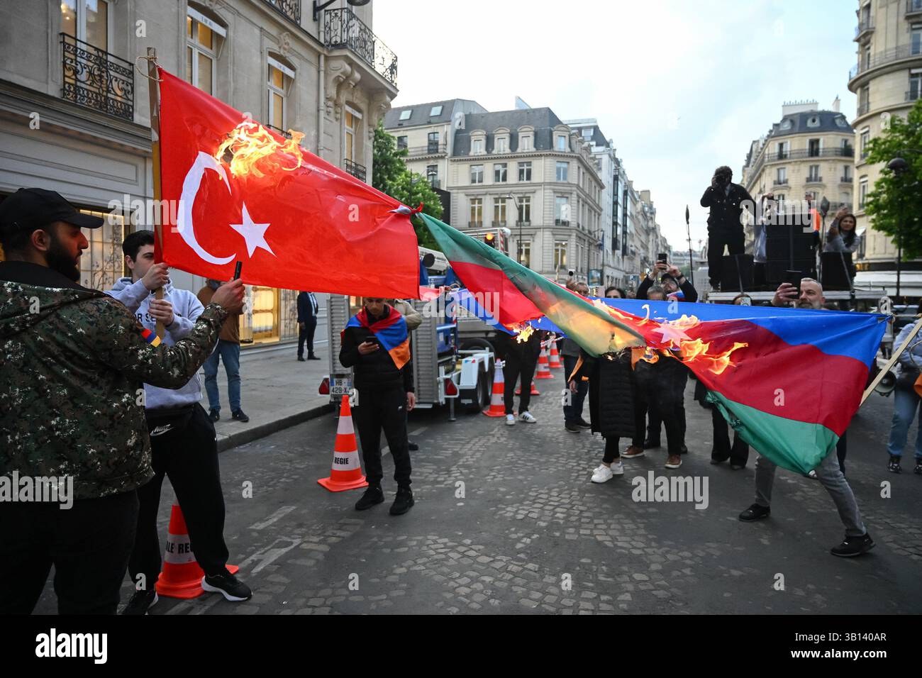 Paris, France. 24th Apr, 2025. Protesters burn the flags of Turkey and ...