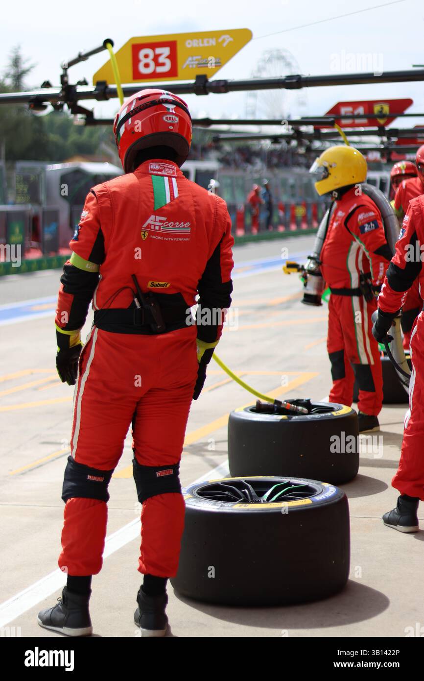 Crew members from AF CORSE stand by in preparation for an upcoming pit ...