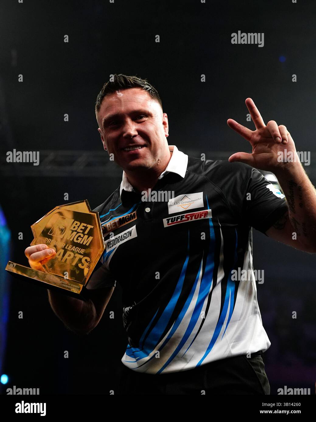 Gerwyn Price lifts the trophy following victory against Luke Humphries (not pictured) during ...