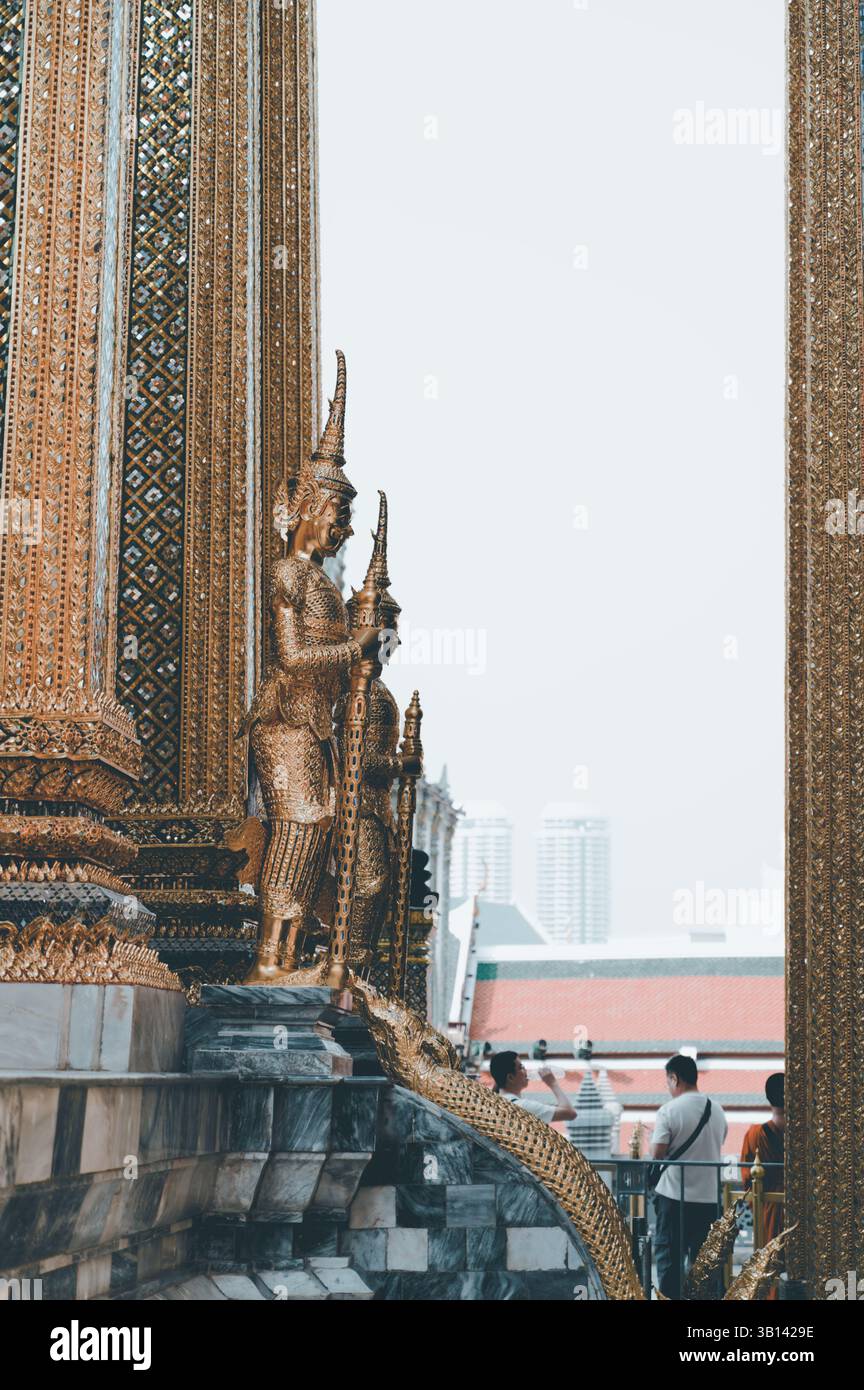 Golden guardian statues stand watch at Wat Phra Kaew Stock Photo - Alamy