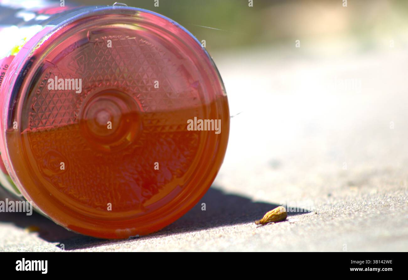 bottom of red sports drink container Stock Photo - Alamy